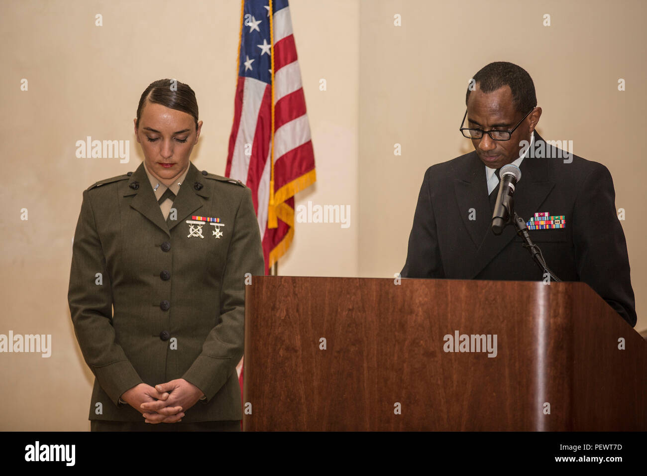U.S. Navy Chaplain CAPT. Darrell Wesley, right, prays during the 1st ...