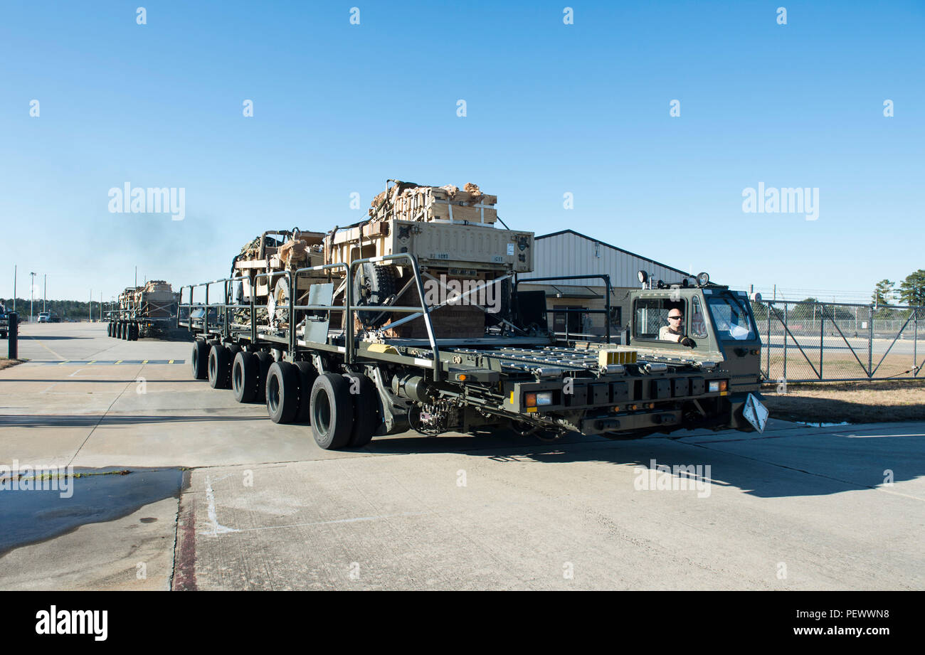 U.S. Air Force Airmen and U.S. Army Soldiers load a HUMVEE onto a C-17 ...
