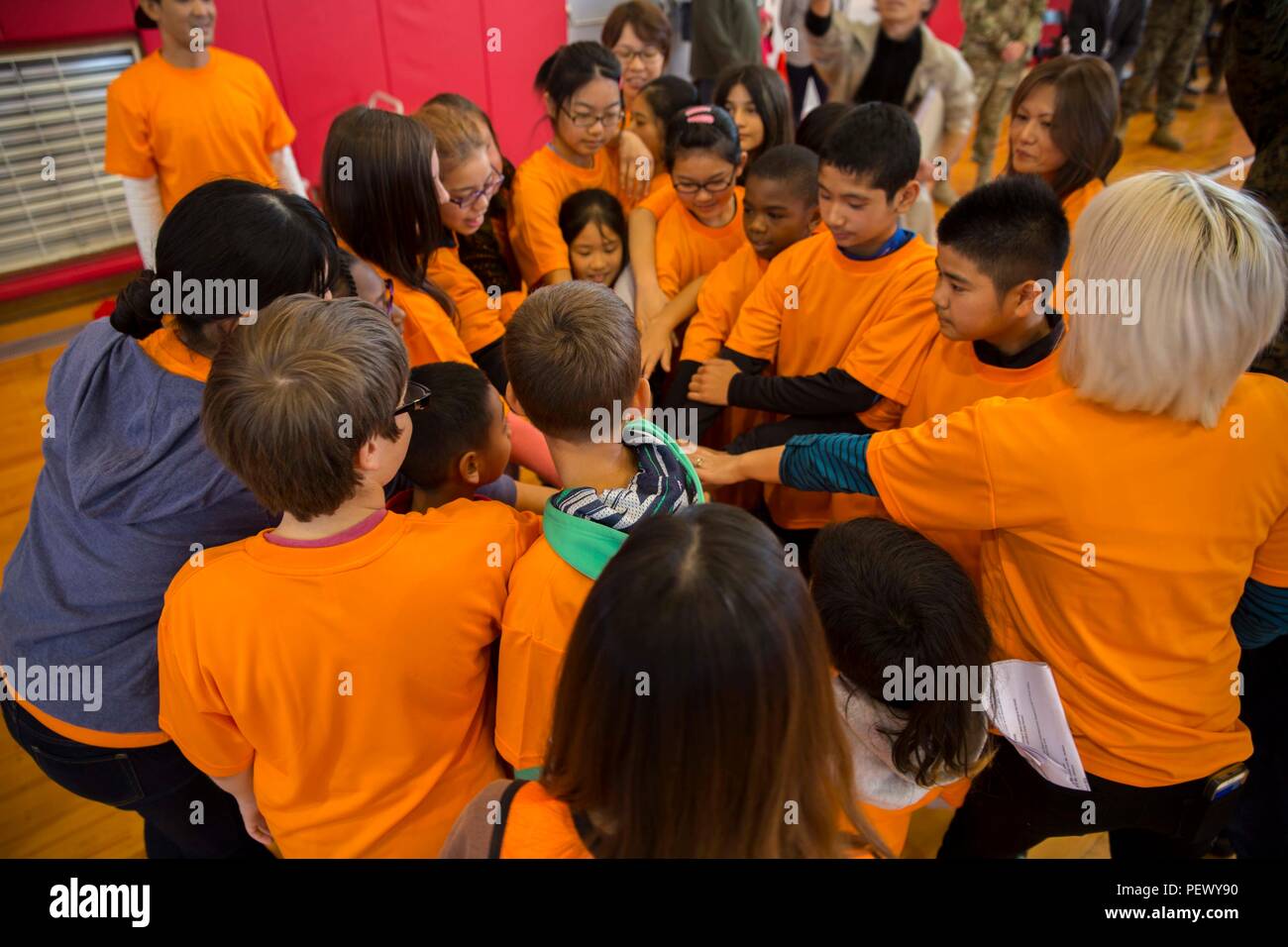 Members from the orange-shirt team finish their huddle prior to an ...