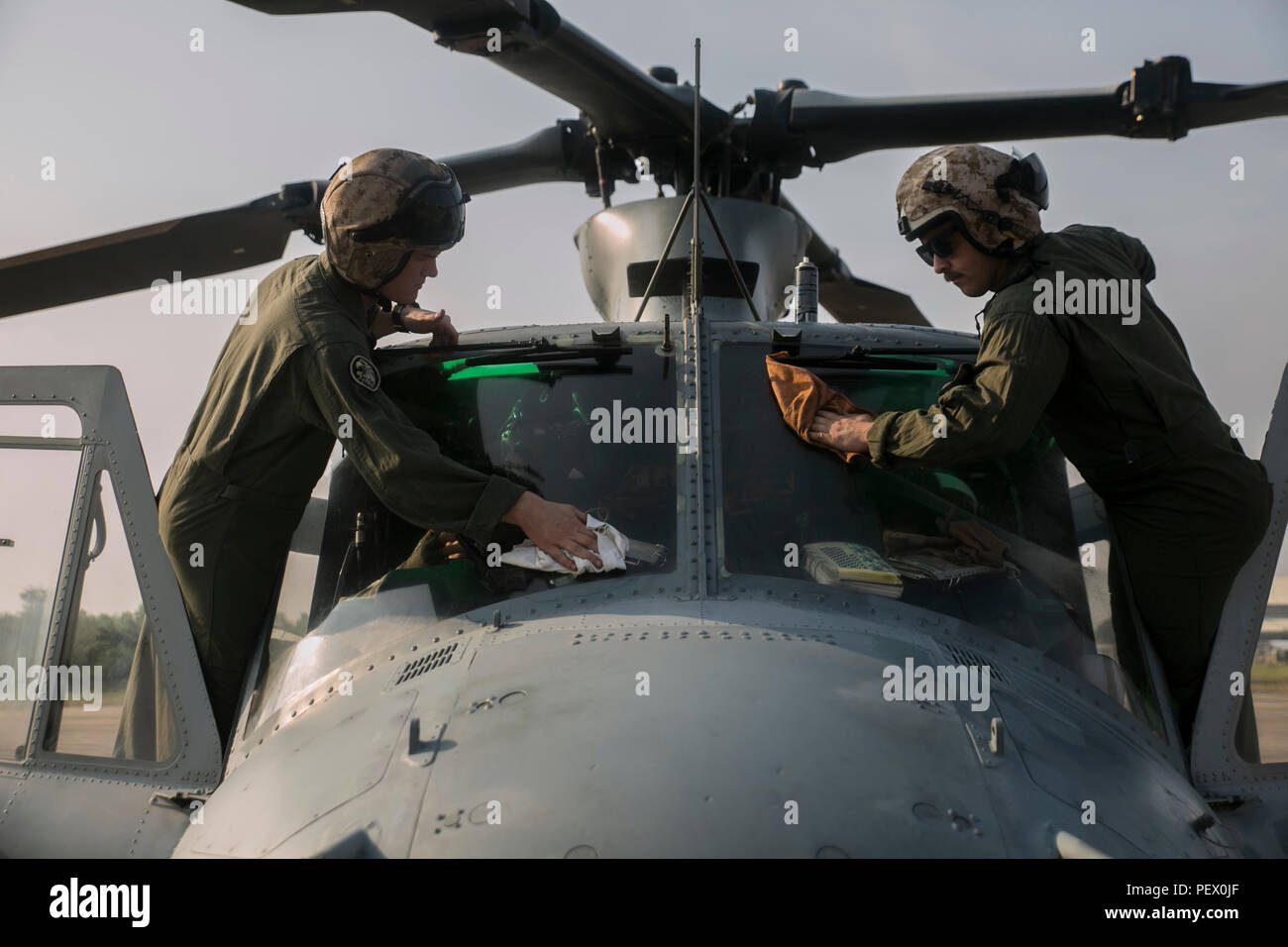 Sgt. Kyle J. Mohr (Left) and Cpl. Erik A. Dudley prepare a UH-1Y Huey ...