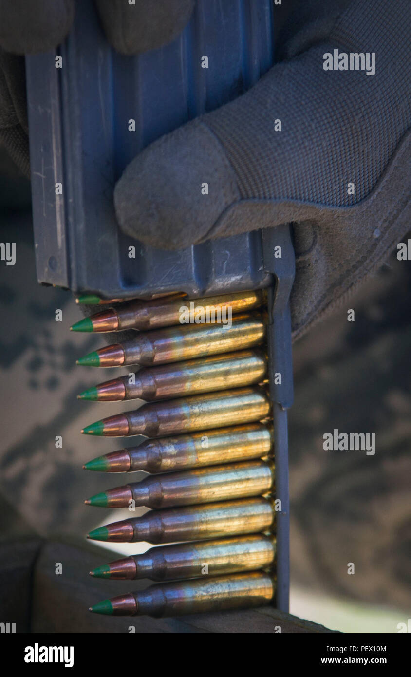 A cadre member loads rounds into a magazine in preperation for a reflex ...