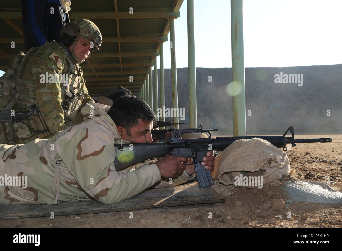 An Australian soldier with Task Group Taji provides instruction to an ...