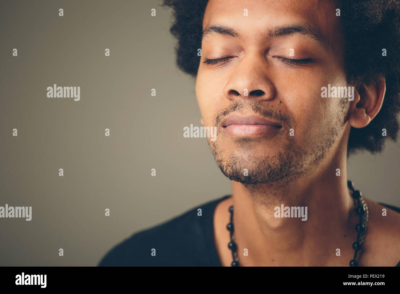 Portrait handsome young man, eyes closed. Stress relief techniques ...