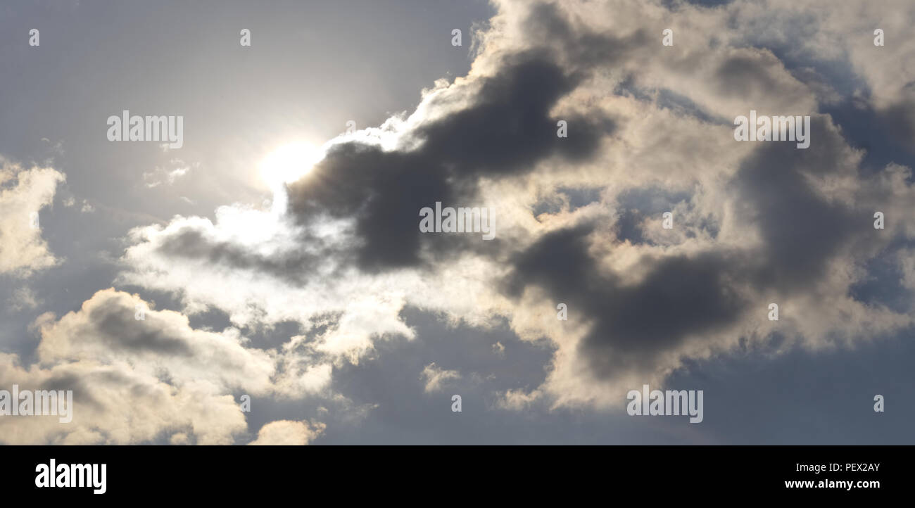 Sun peeking over Stock Photo - Alamy