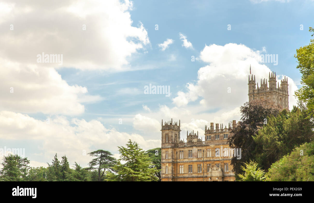 Highclere castle famous as downton abbey with green trees and blue sky ...