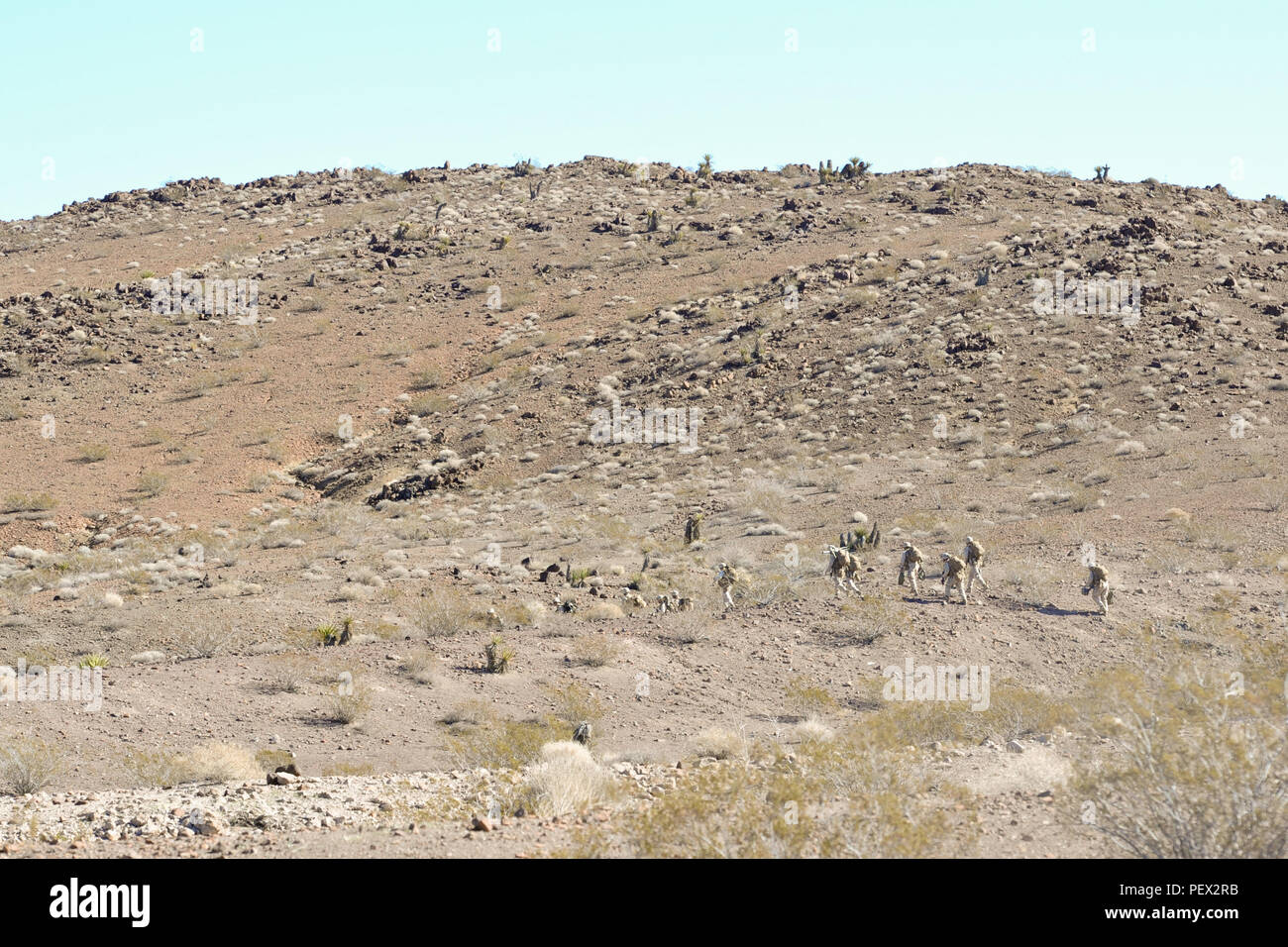 U.S. Marines walk up a mountain to an objective point during Integrated ...