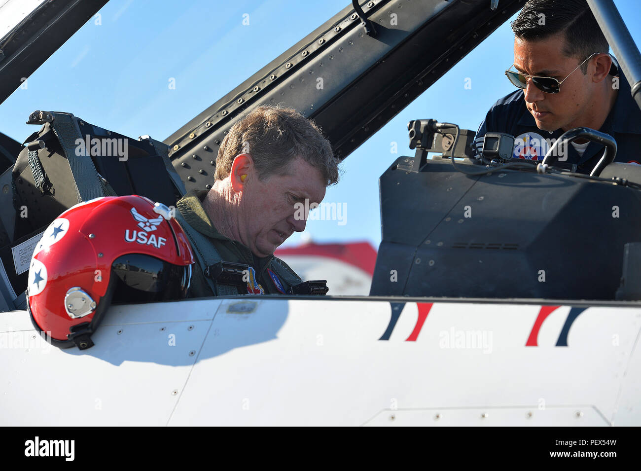 Bill Elliott, NASCAR Hall of Famer, gets strapped in to the back seat ...