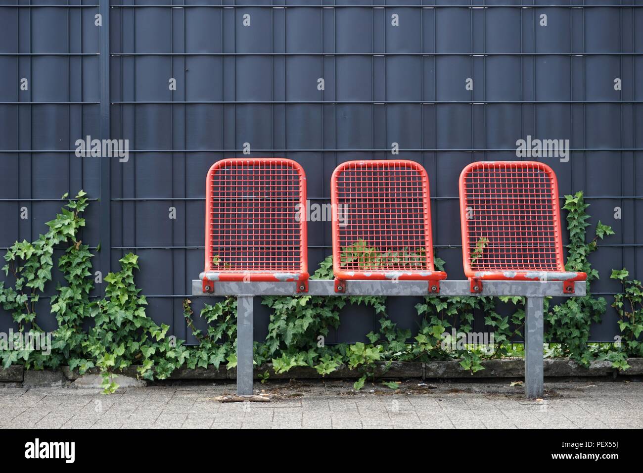 bas station seats waiting in red grey background Stock Photo - Alamy