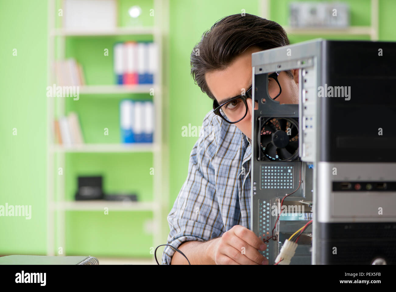 Computer engineer repairing broken desktop Stock Photo - Alamy
