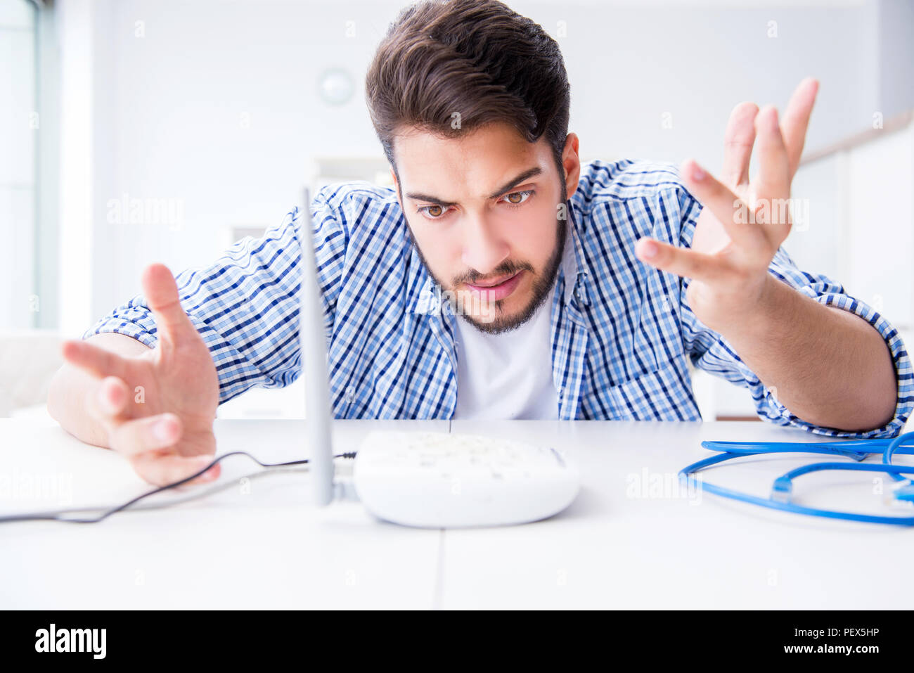 Frustrated young man due to weak internet reception Stock Photo - Alamy