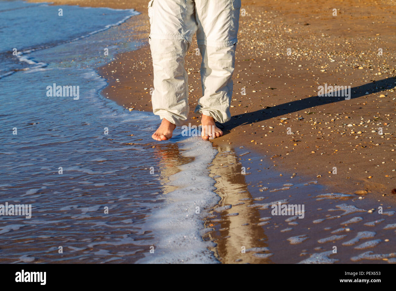 barefoot man walking on the waves of the surf Stock Photo - Alamy