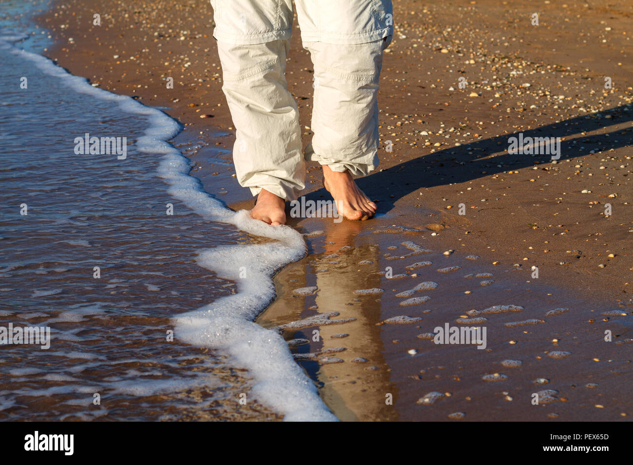 barefoot man walking on the waves of the surf Stock Photo - Alamy