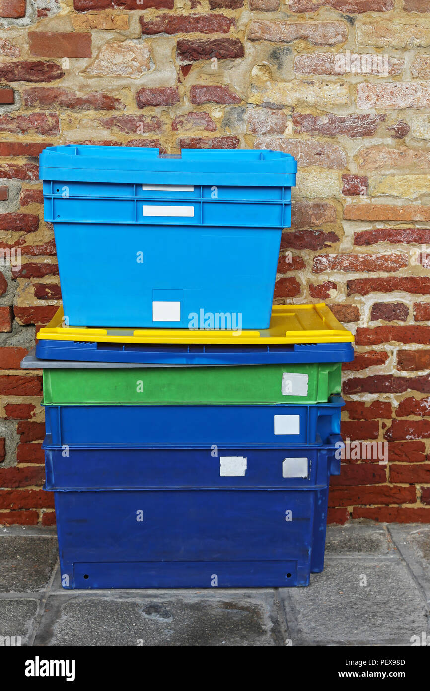 Pile of plastic shipping boxes for delivery Stock Photo - Alamy