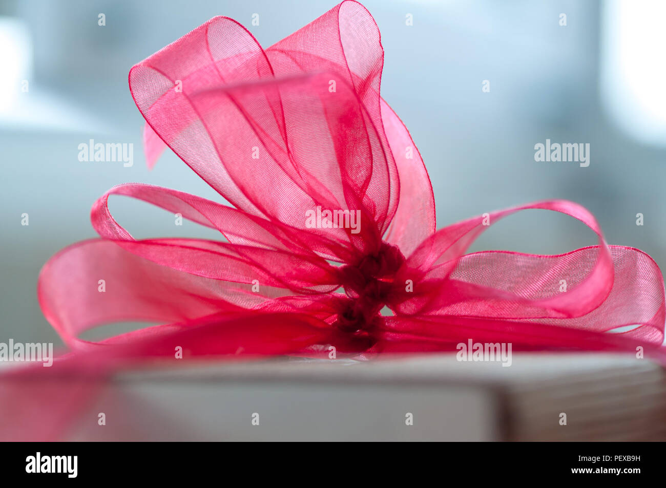 Red ribbon wrapping around box hi-res stock photography and images - Alamy