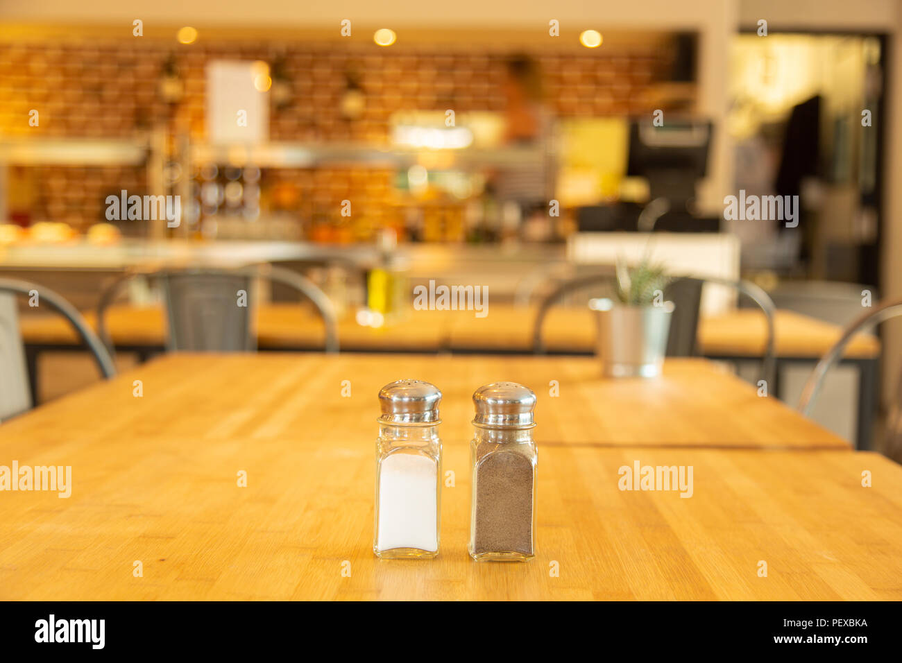 Pepper shaker and salt shaker on a bamboo table Stock Photo - Alamy