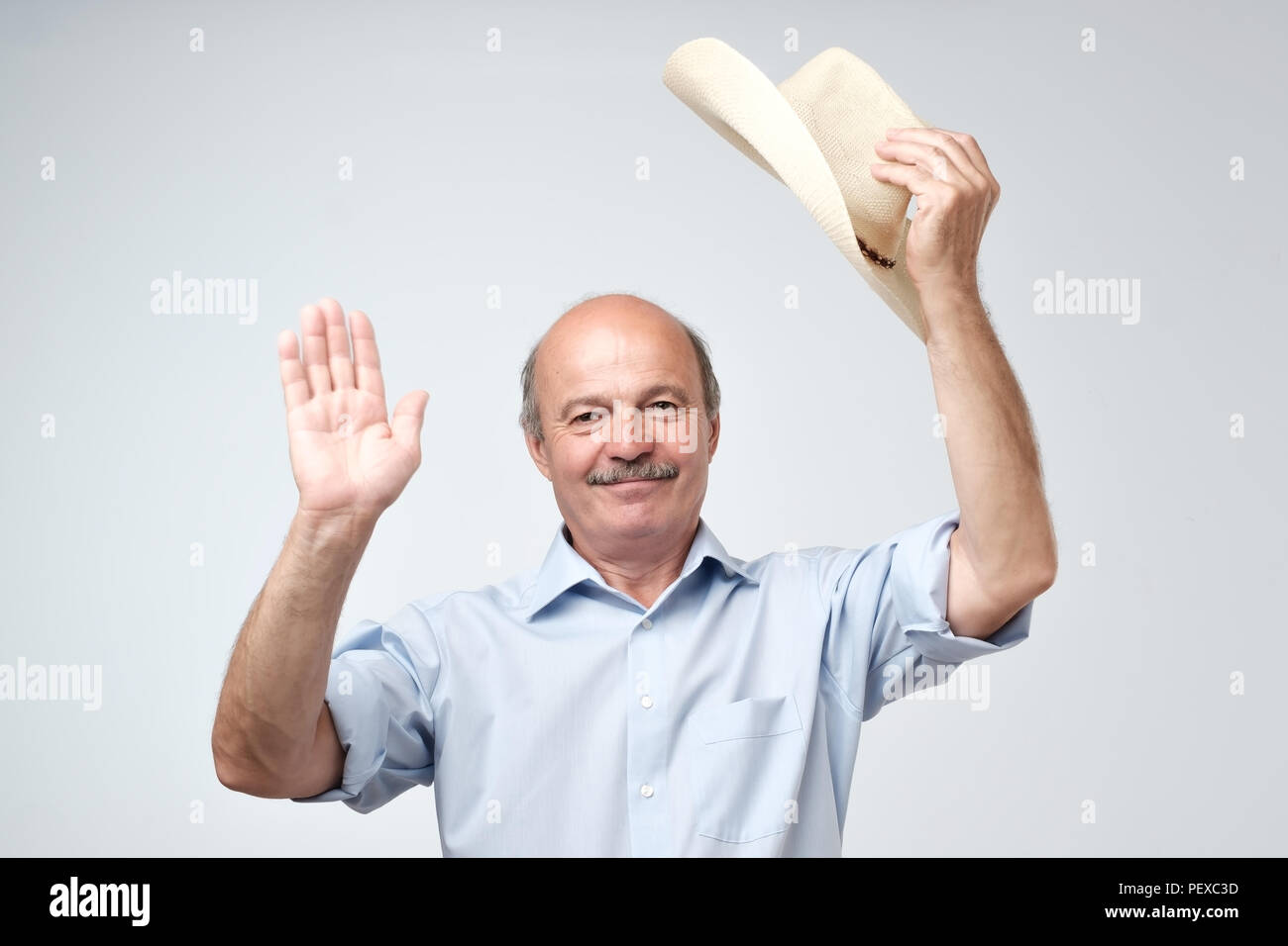 Cowboy waving hat hi-res stock photography and images - Alamy