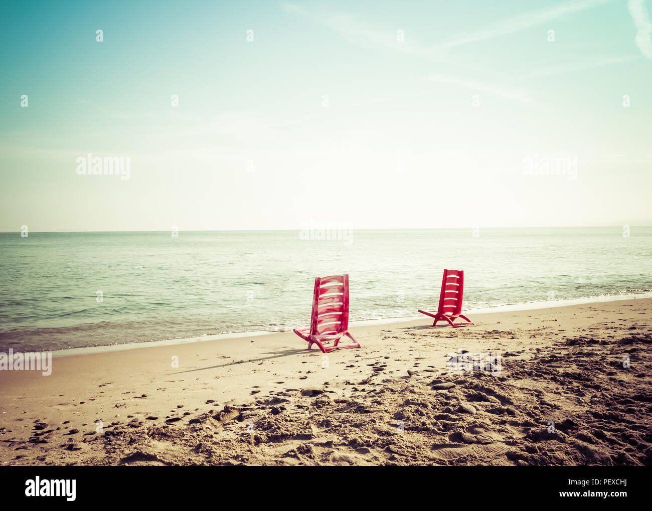 two red chairs on the beach Stock Photo - Alamy