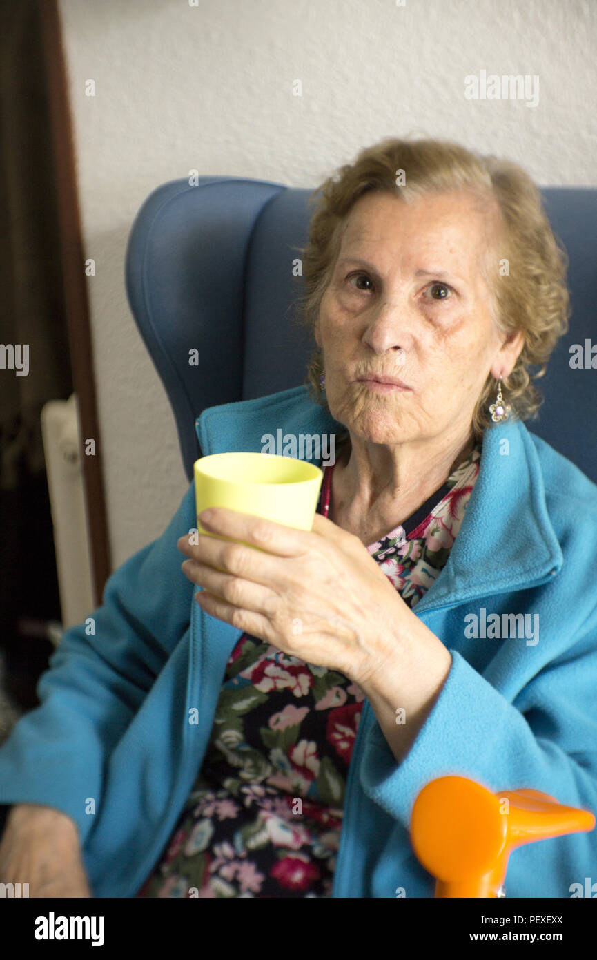 Older woman drinking water from a glass to hydrate Stock Photo - Alamy