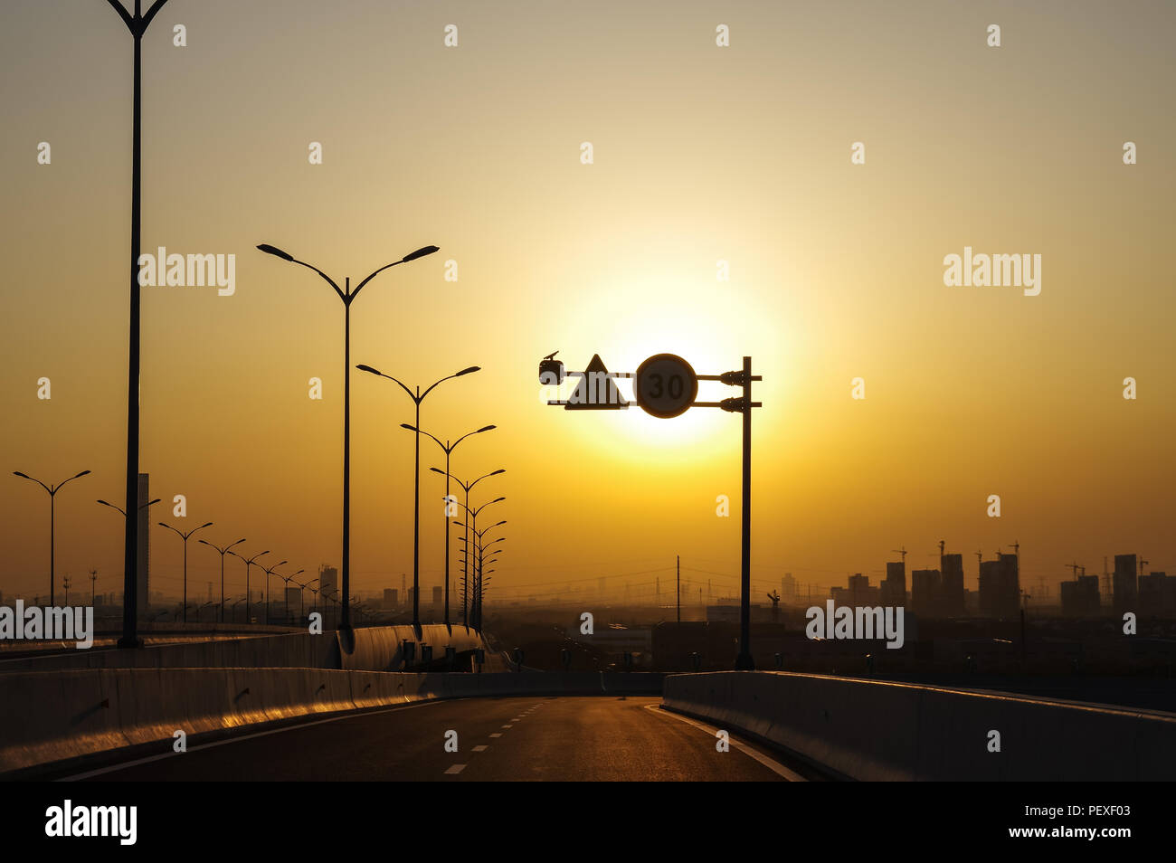 Traffic Signs in the Road at Sunset Stock Photo - Alamy