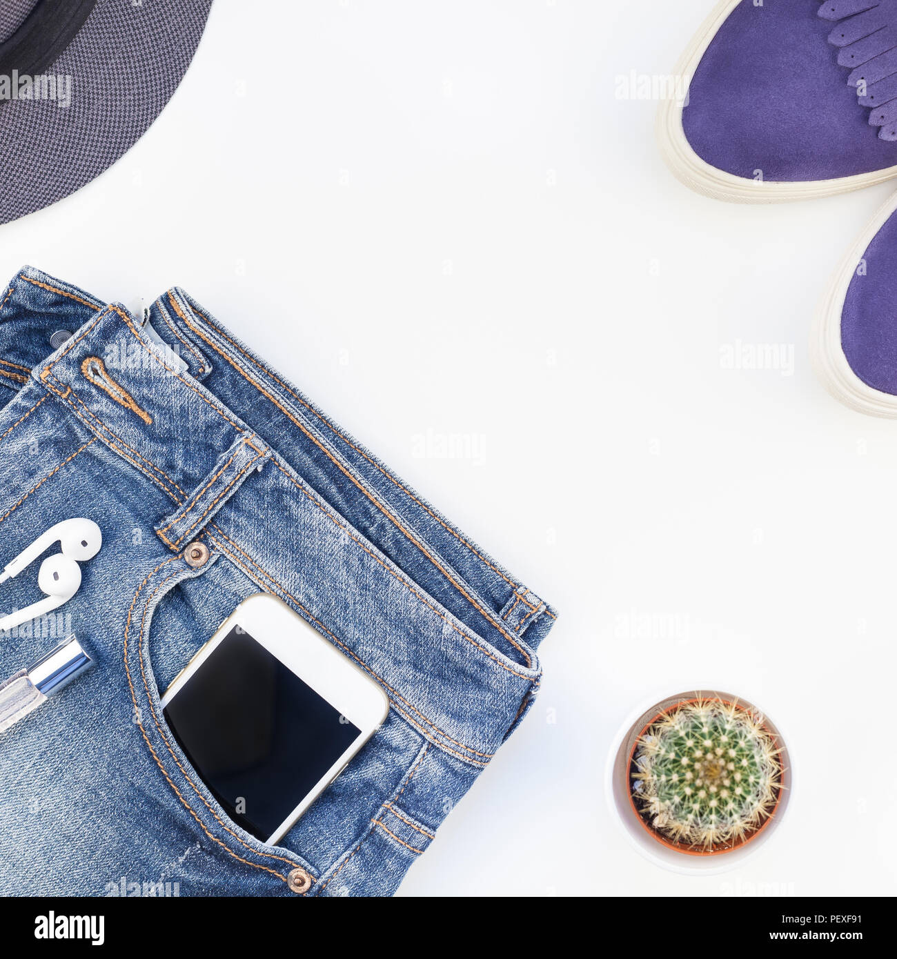 Square Flat lay of suede shoes, blue jeans, grey hat, cactus and ...