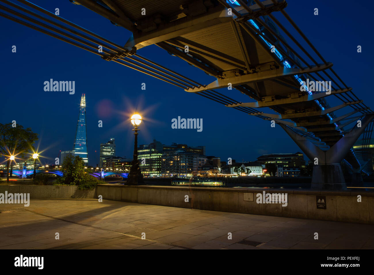 The Shard, London, photographed from below Millennium Bridge at night ...