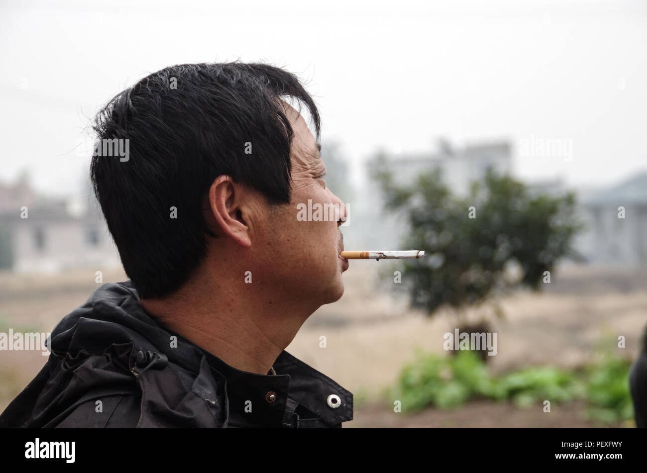 Old Chinese Man Smoking Cigarette High Resolution Stock Photography and ...