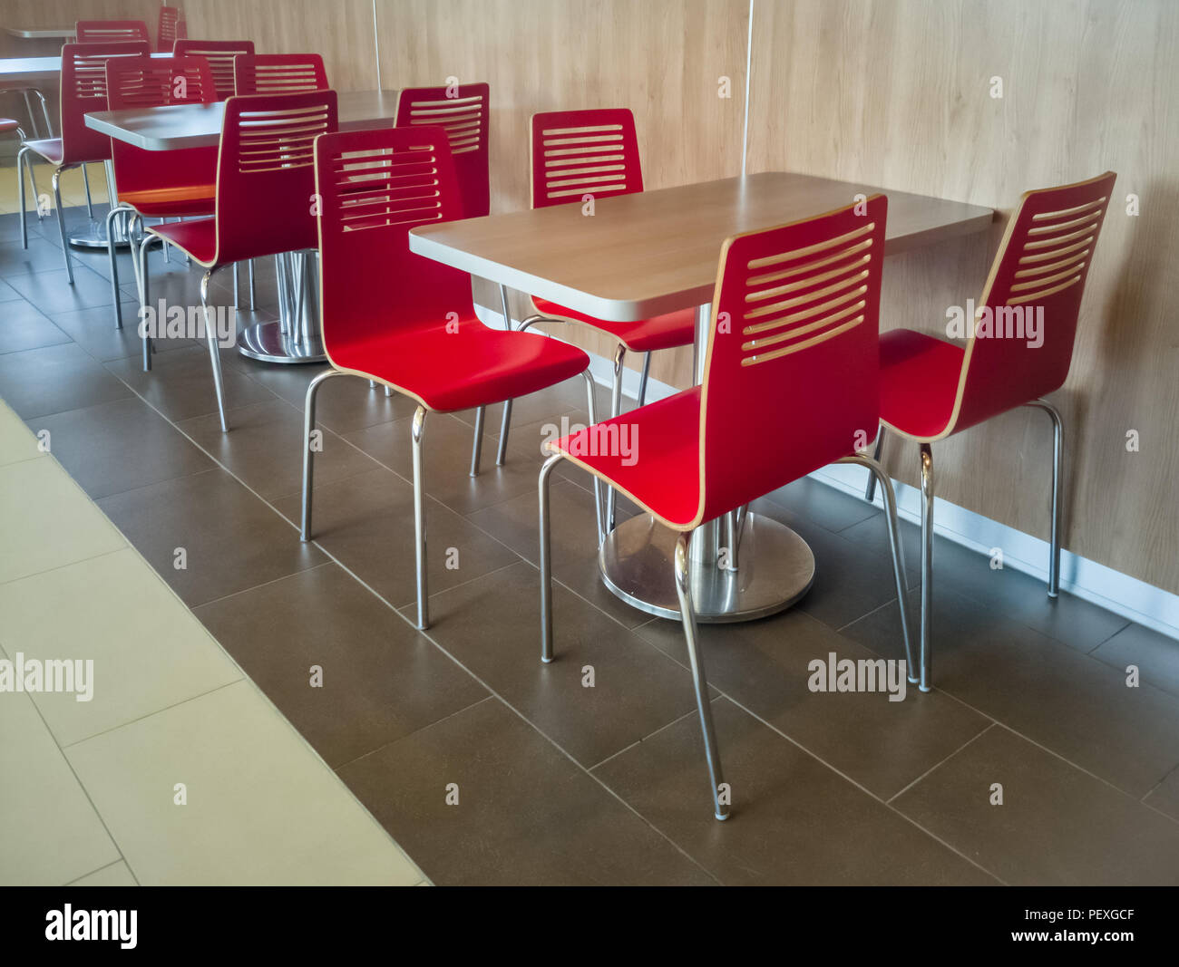 Red cafeteria diner chairs and tables Stock Photo - Alamy