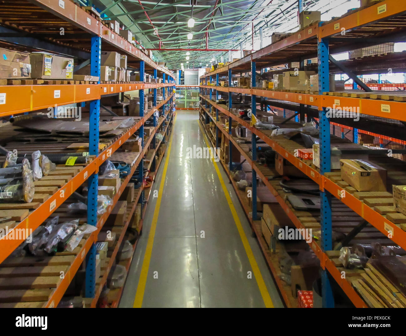 Warehouse store aisle with stacked shelving Stock Photo - Alamy