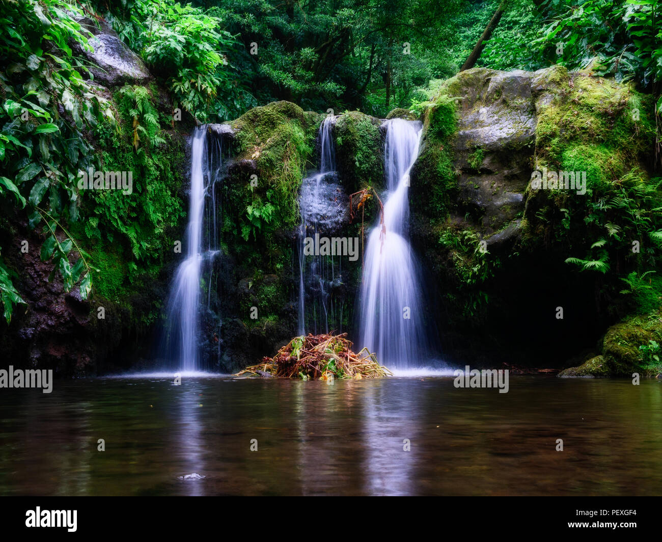 Long exposure picture of a beautiful waterfall with little lake in the ...