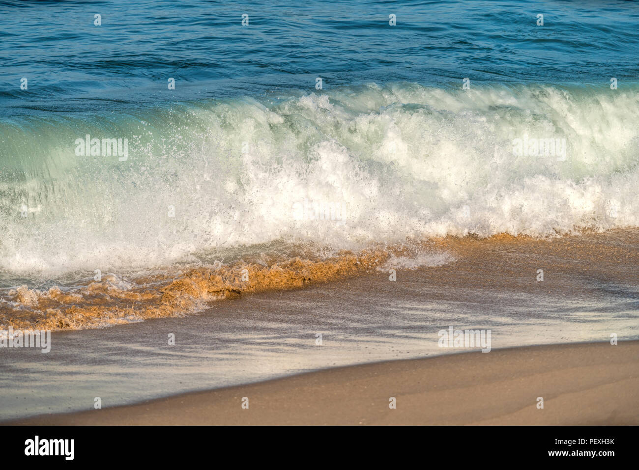 Breaking waves on a beach Stock Photo - Alamy