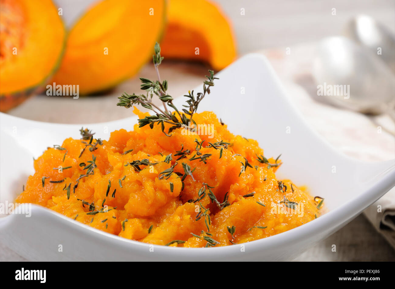 Baked pumpkin with a tender, juicy pulp flavored with thyme. Close-up ...