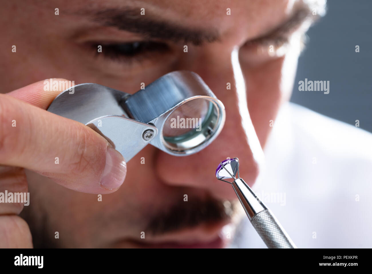 Jeweler inspecting diamond hi-res stock photography and images - Alamy
