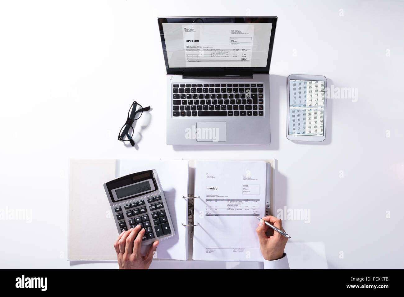 High Angle View Of Businessperson Calculating Invoice With Laptop On ...