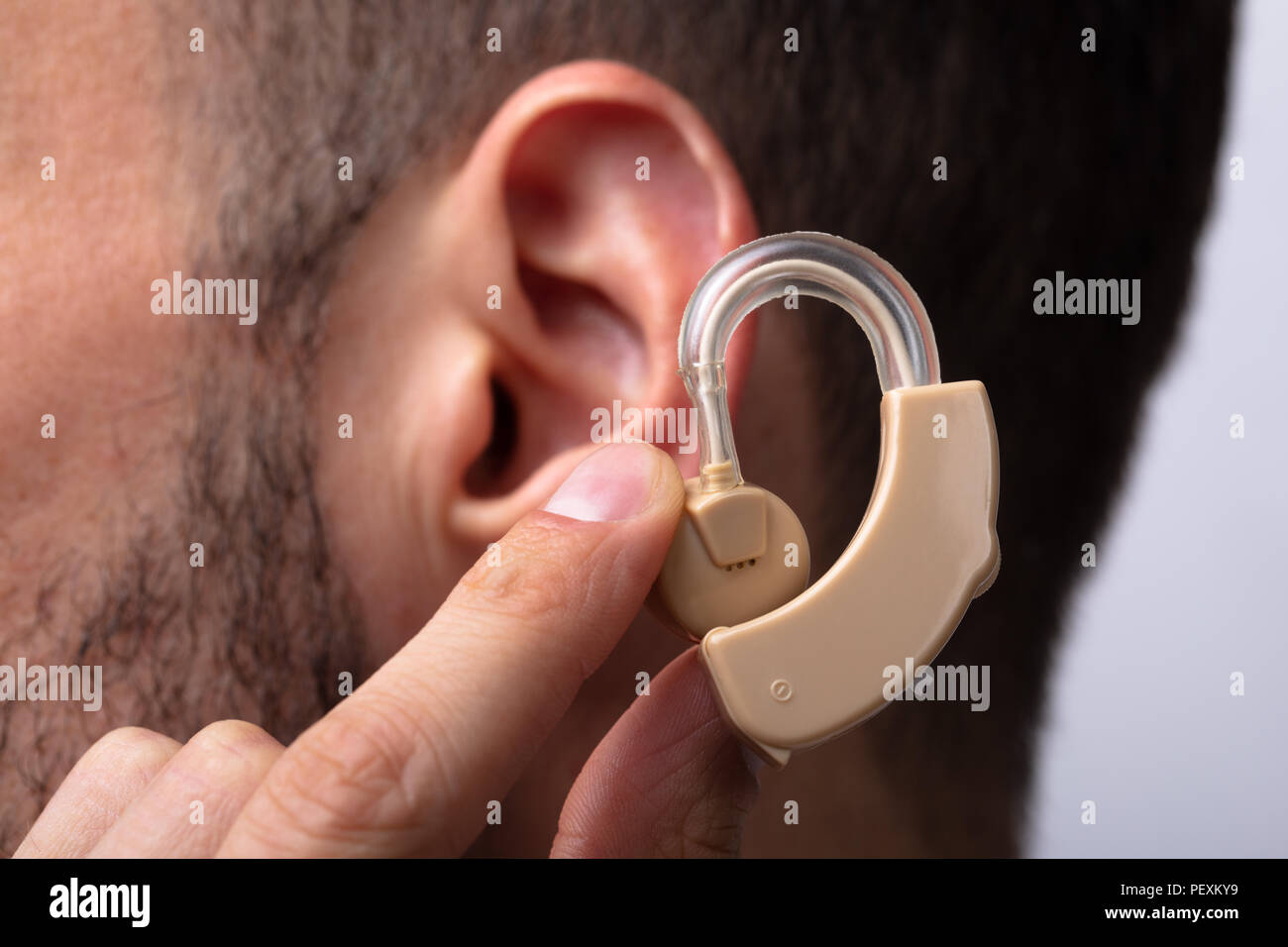 Mans hand holding ear hi-res stock photography and images - Alamy