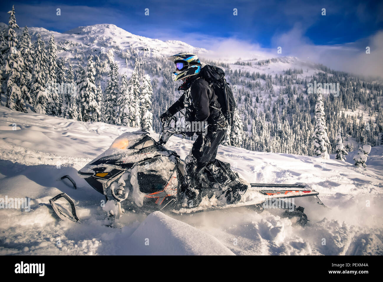 Man riding snowmobile in Callaghan Valley, Whistler, British Columbia ...