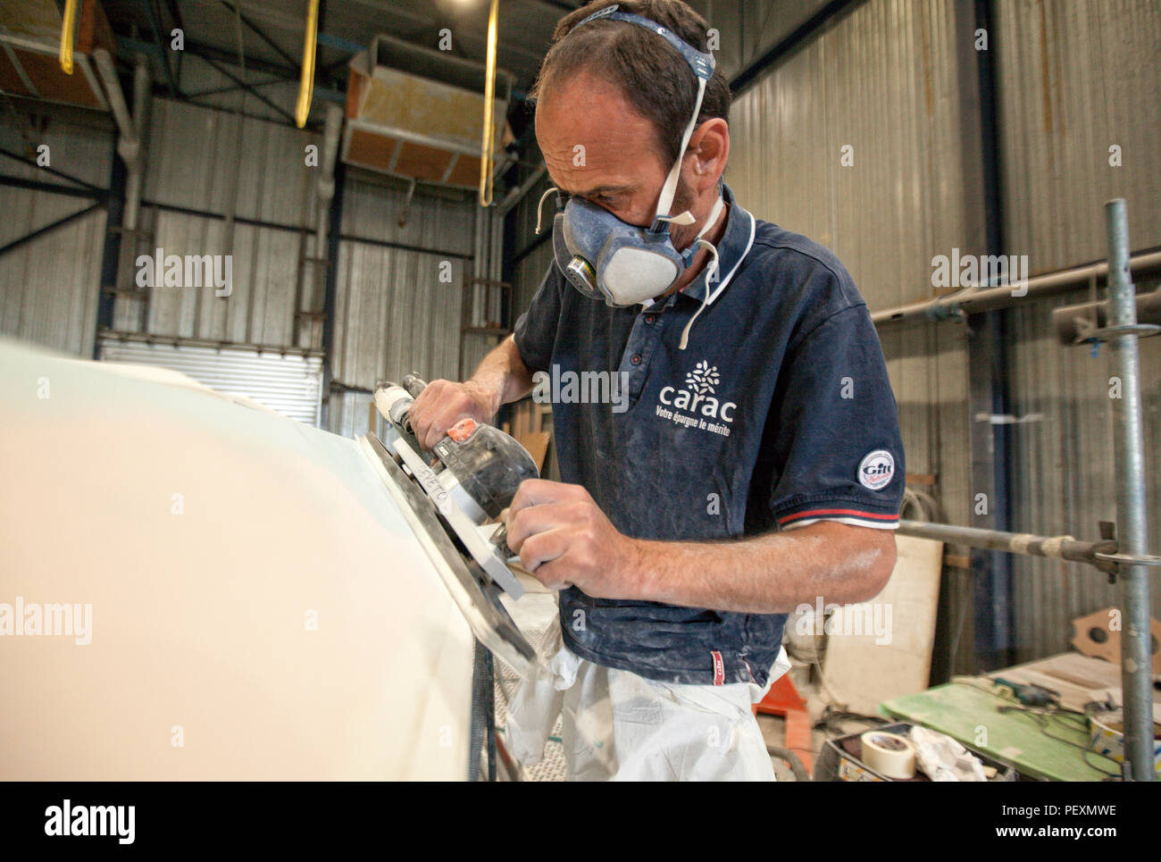 Man using sanding machine while building ship, Lorient Keroman ...