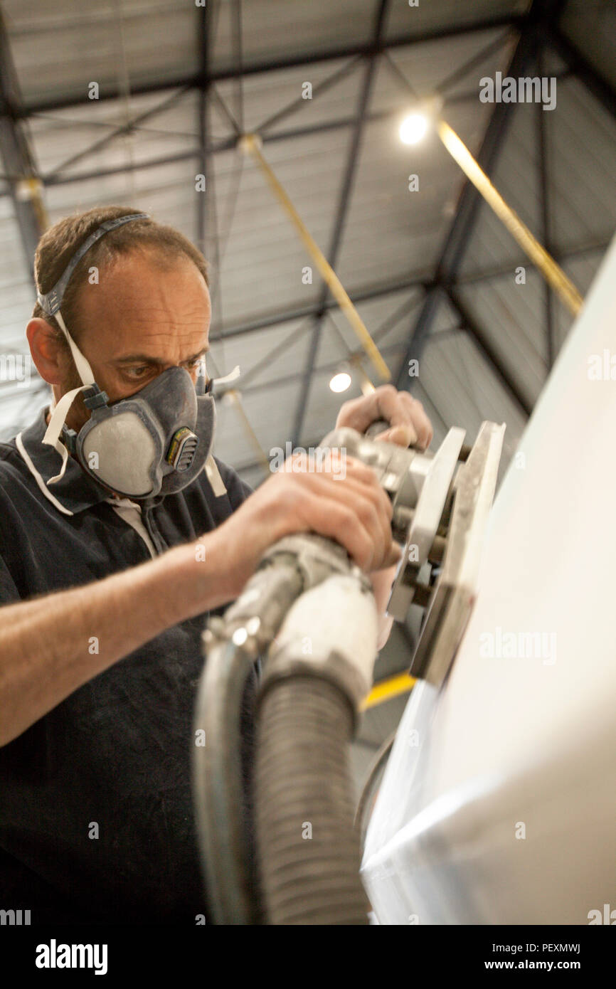 Man using sanding machine while building ship, Lorient Keroman ...