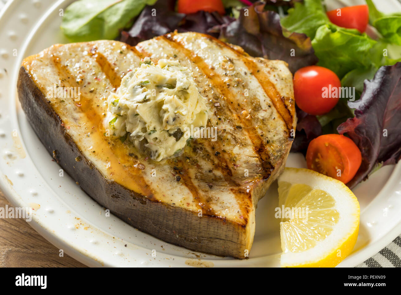 Organic Grilled Swordfish Steak with a Side Salad Stock Photo - Alamy
