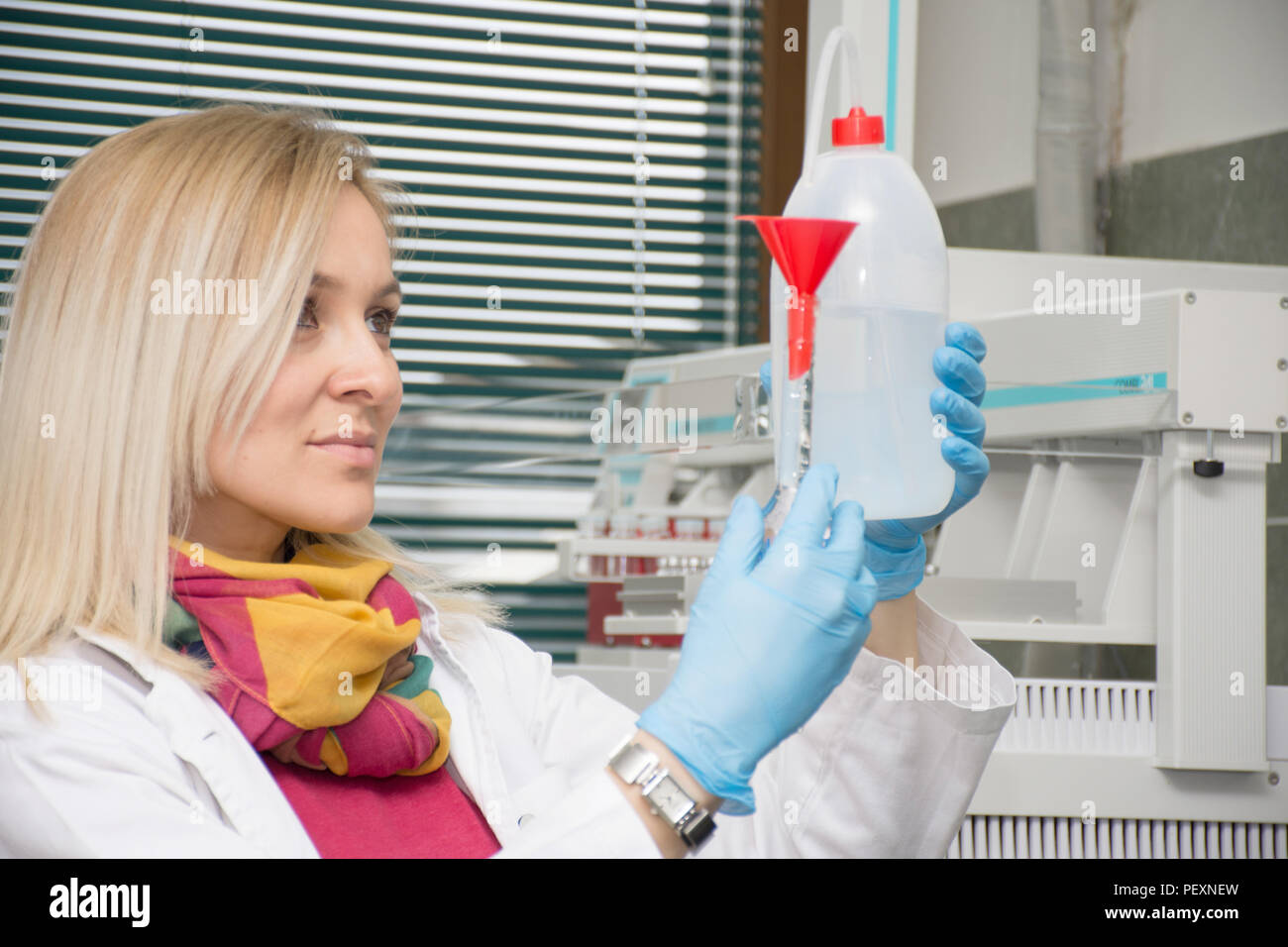 Portrait of a chemist holding a tube with liquid Stock Photo - Alamy