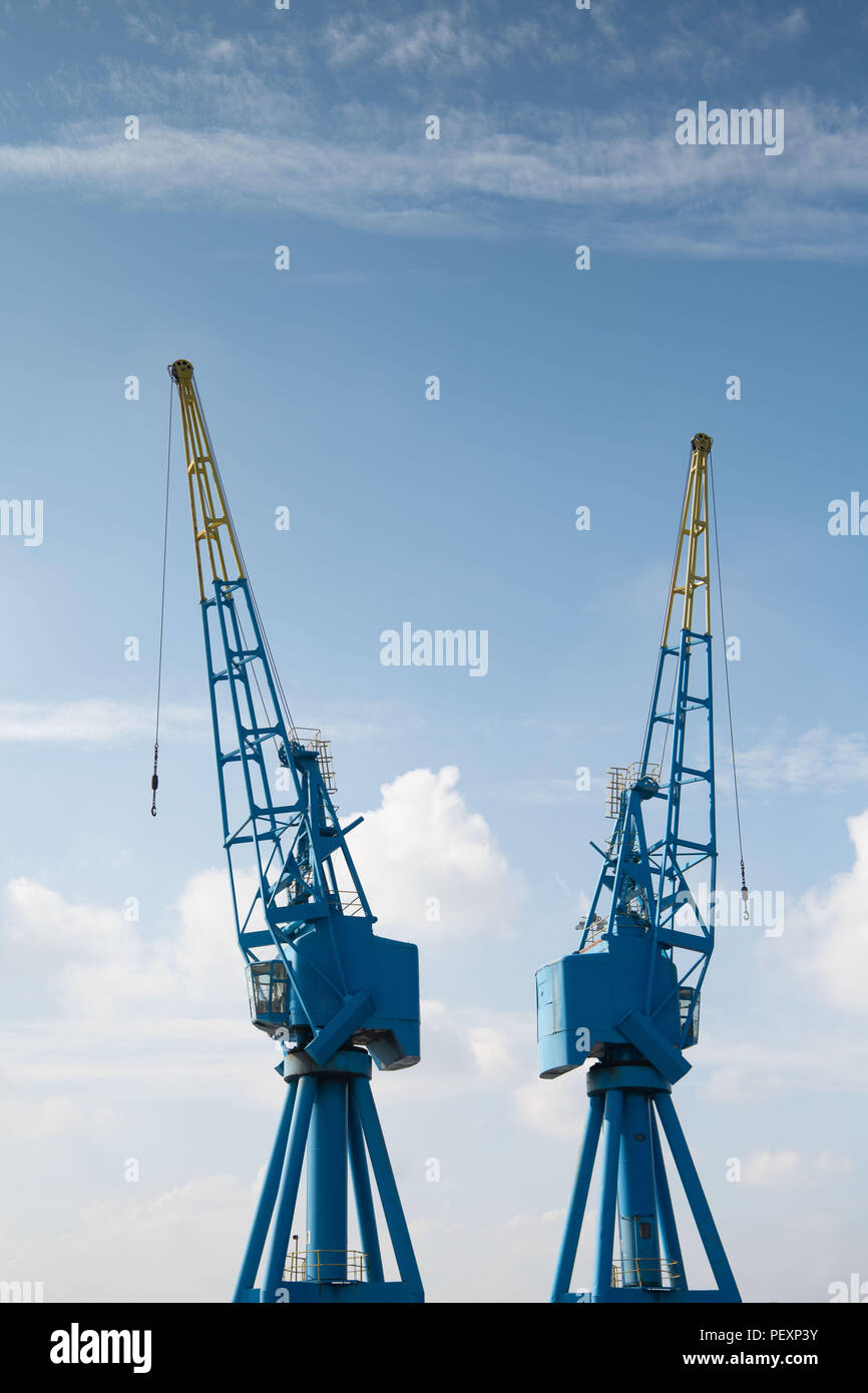 Blue cranes seen against a blue background at the port of Cardiff on ...