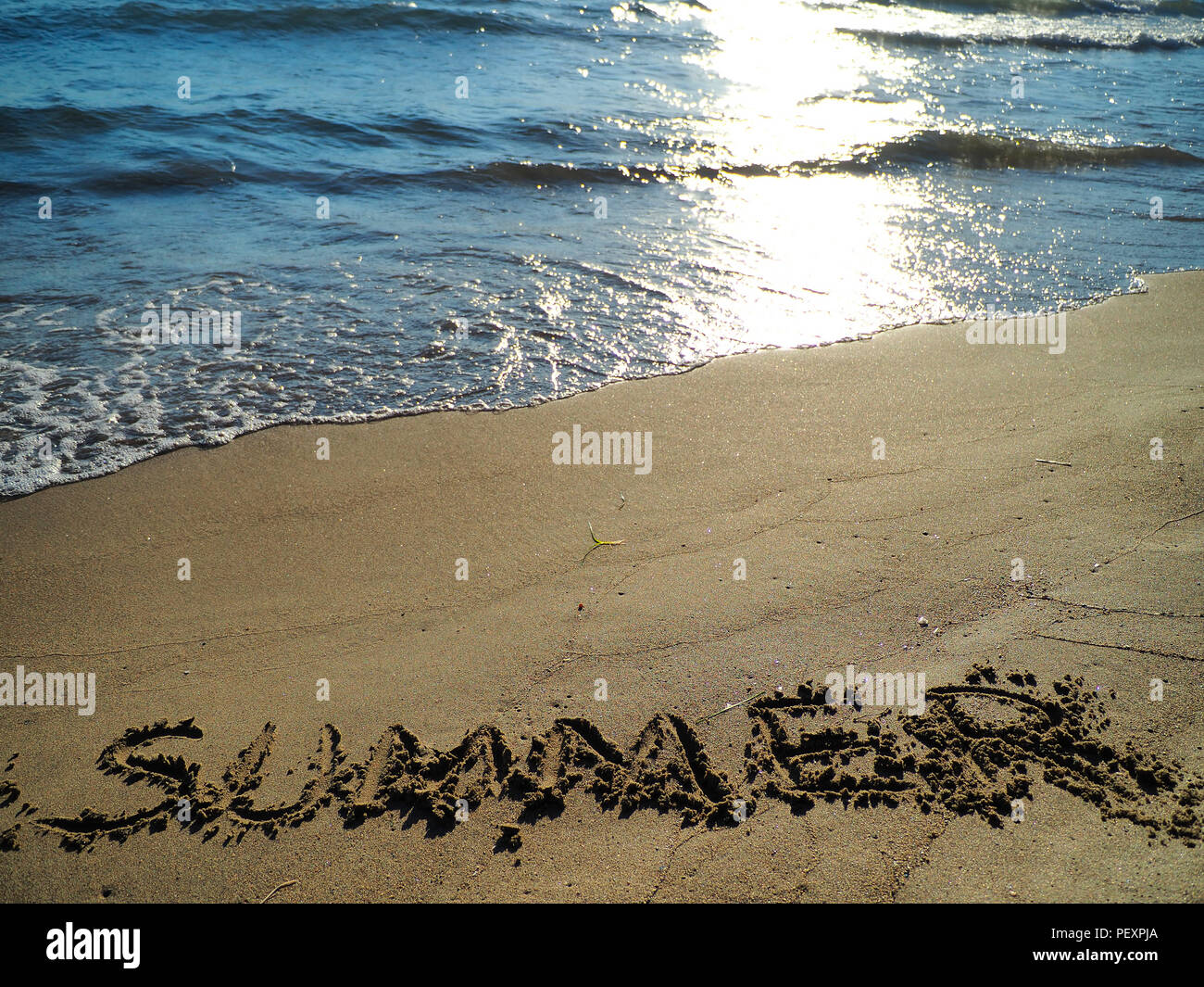 summer text and waves hitting the beach Stock Photo - Alamy