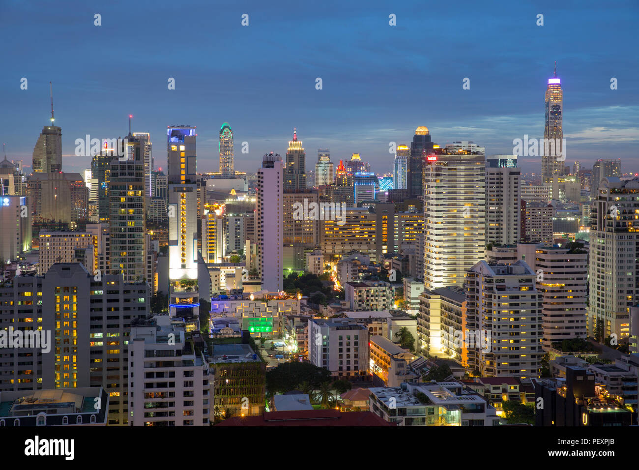 a big asia city by night to the sunrise with all the lights on the ...