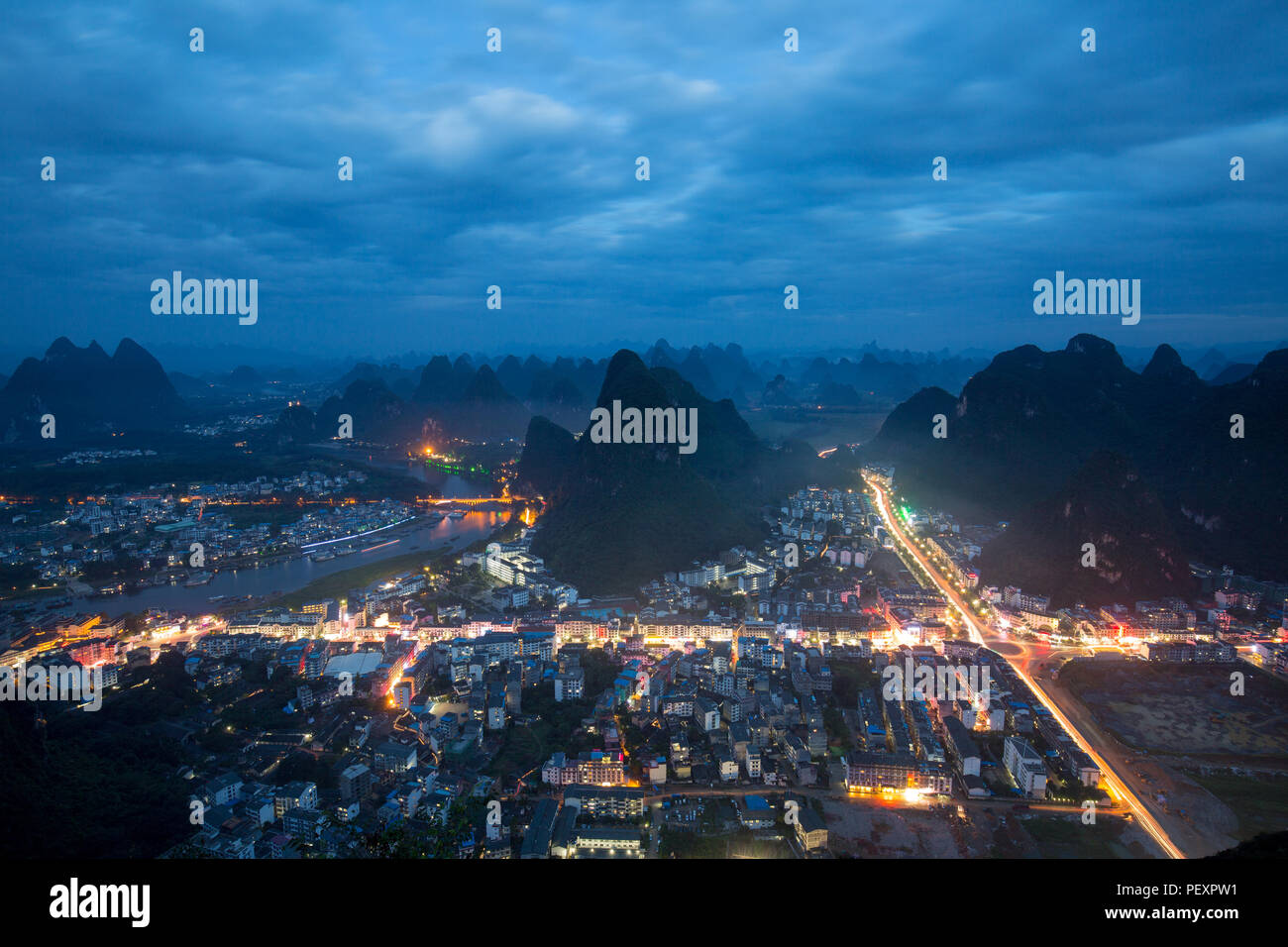 a big asia city by night to the sunrise with all the lights on the ...