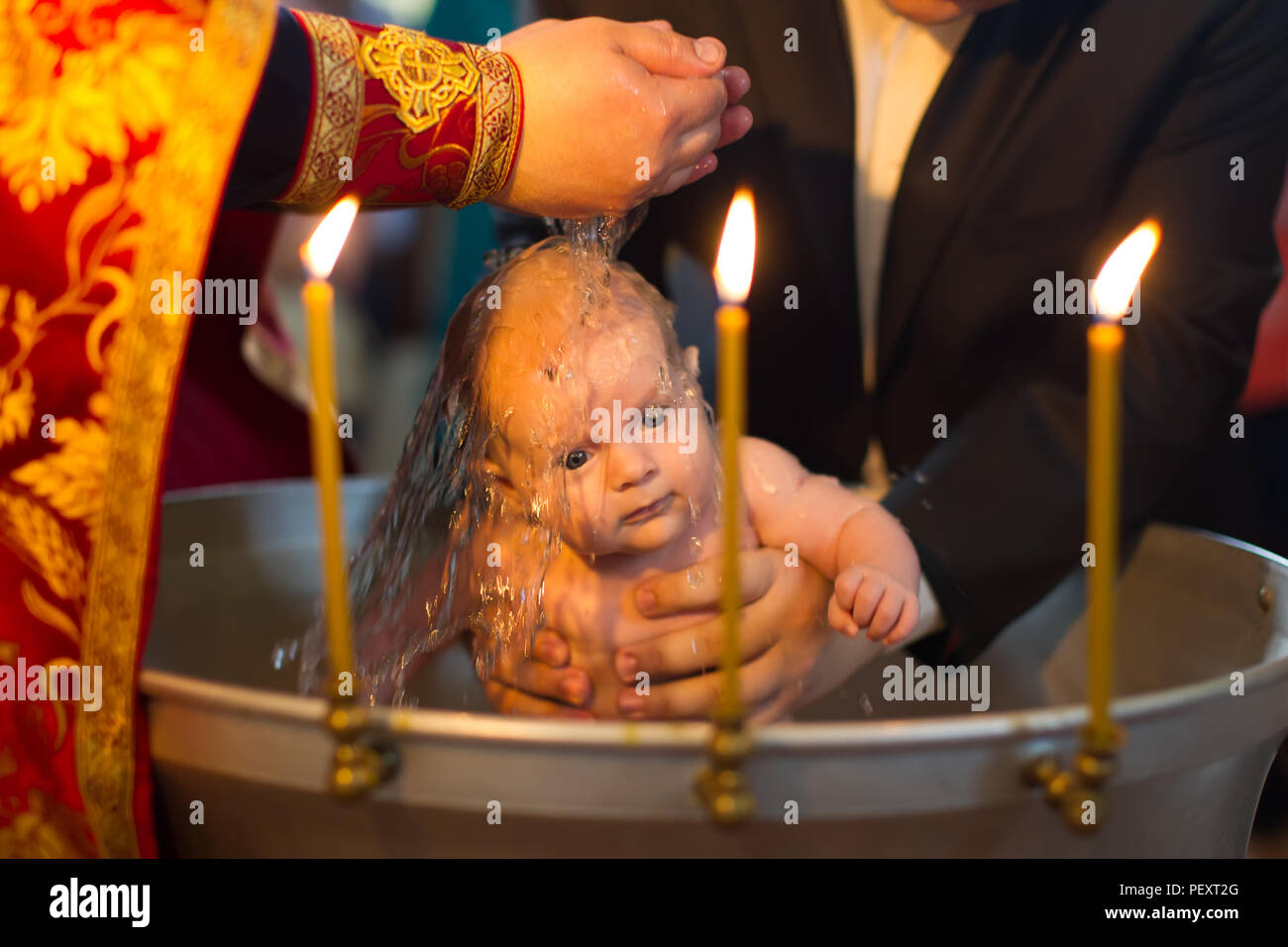 . Baptism of a newborn child.The rite of Orthodox baptism. The child is ...