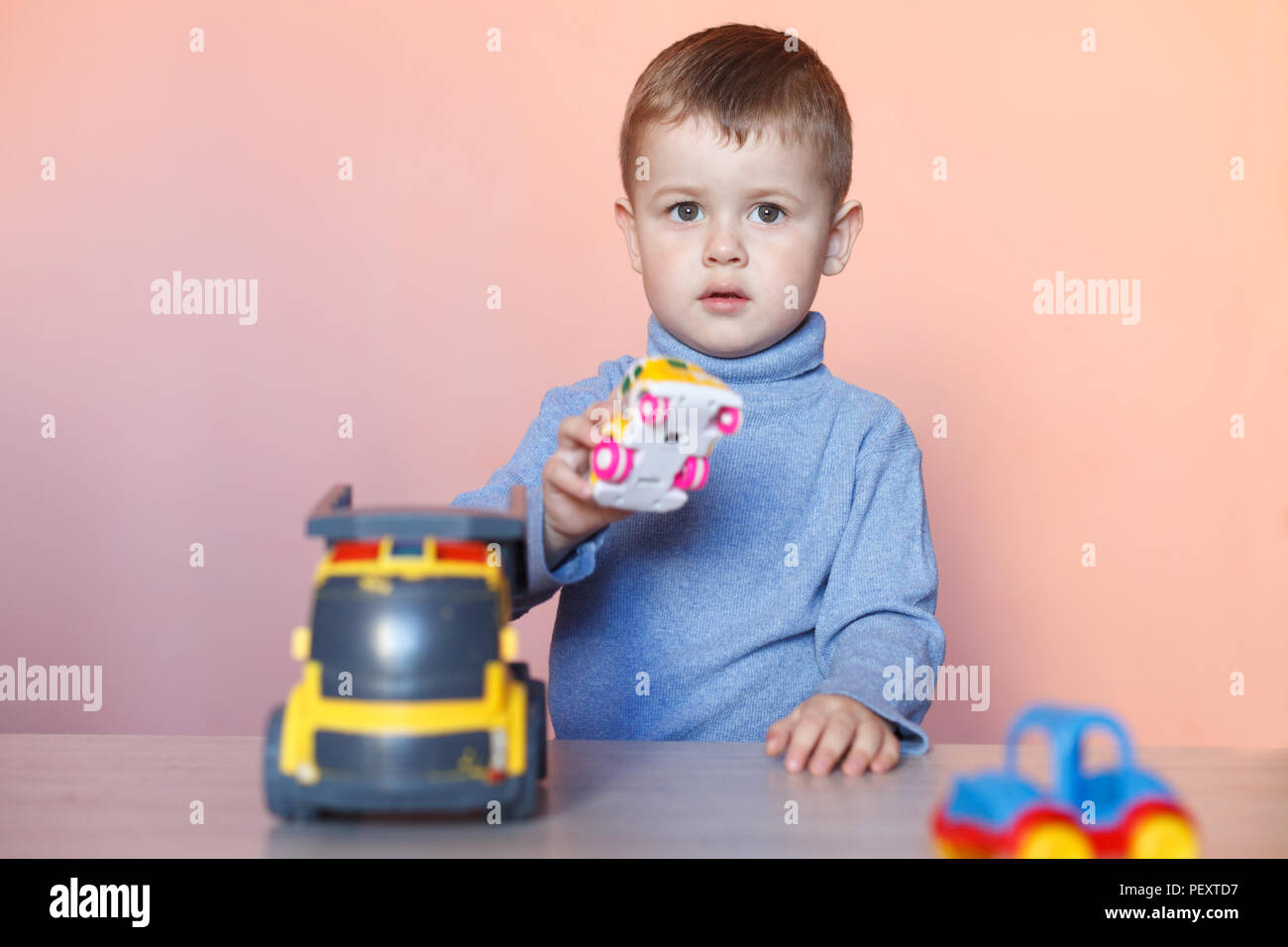 A cute little boy playing with model car collection. Toy mess in child ...