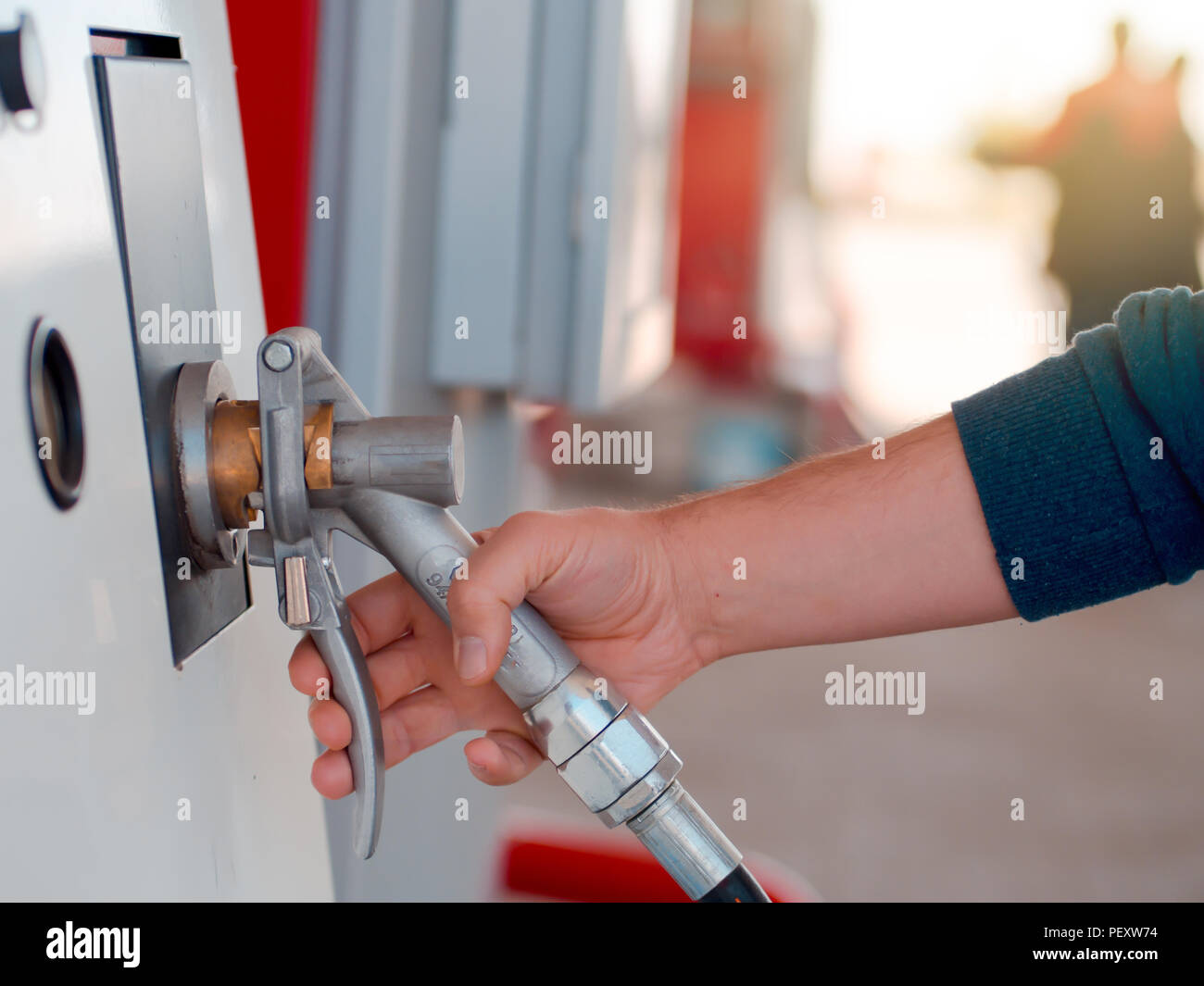 Hand holding gas nozzle hi-res stock photography and images - Alamy