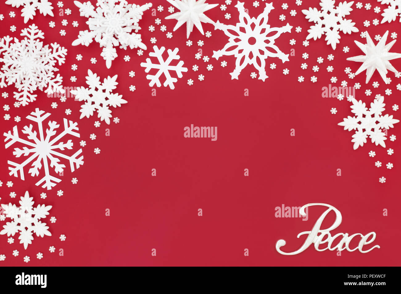 Christmas peace sign and white snowflake decorations on red background ...
