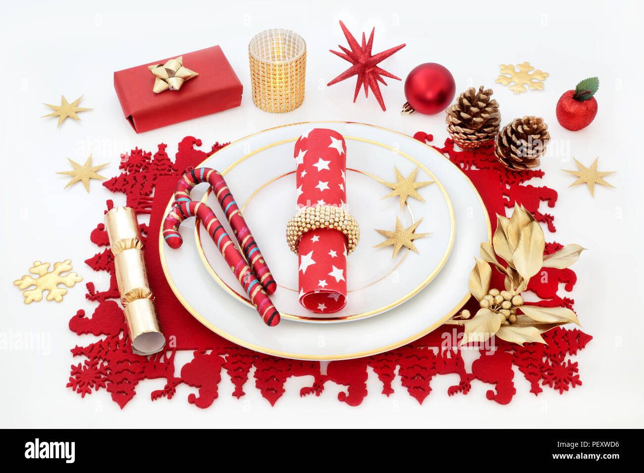 Christmas dinner table setting with porcelain plates, bauble ...