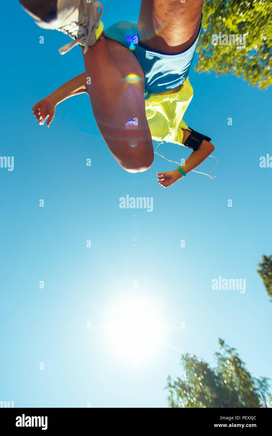 Muscles woman legs while jogging in the park Stock Photo - Alamy