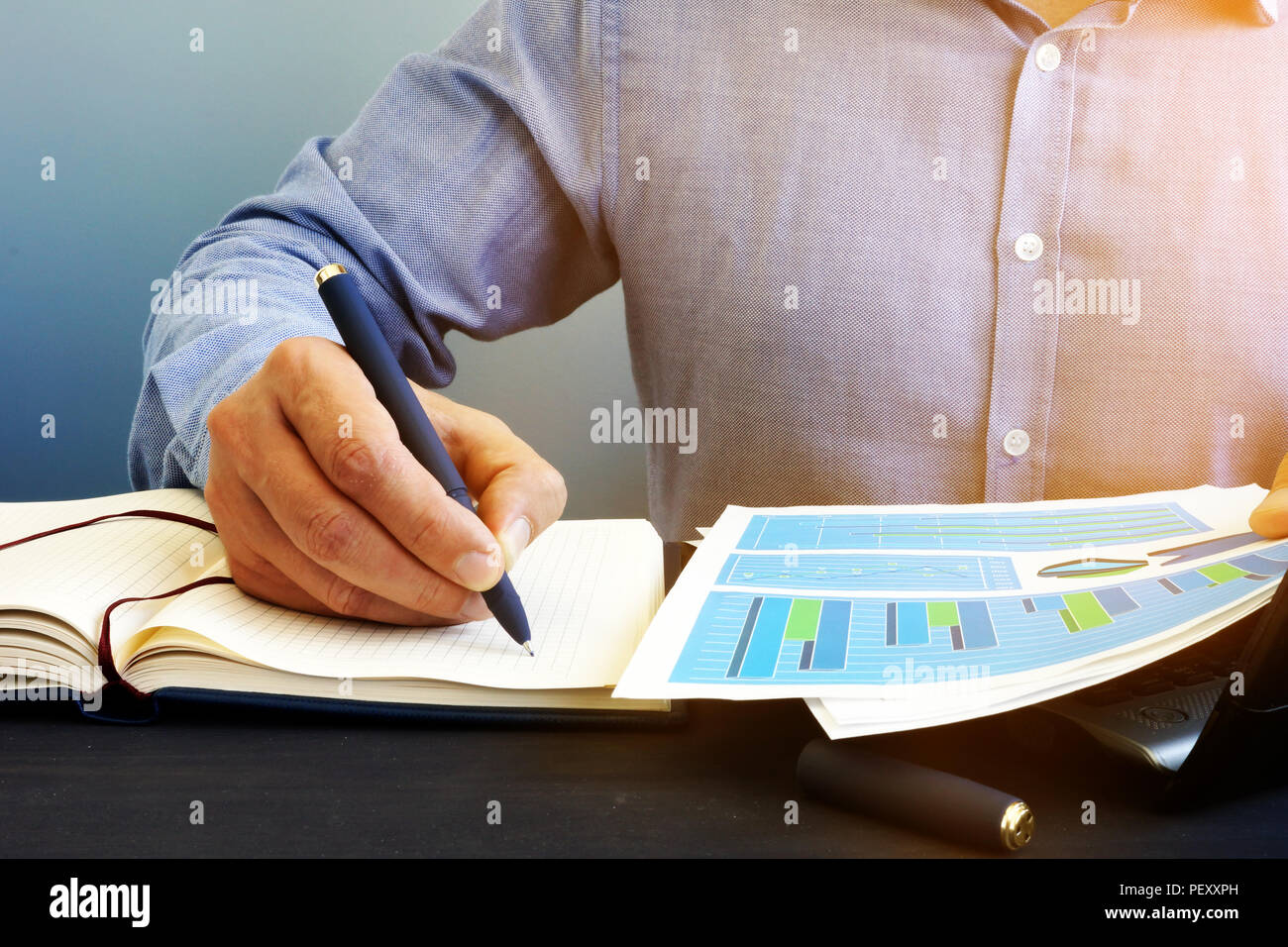 Businessman is writing notices in the notepad. Work with financial ...